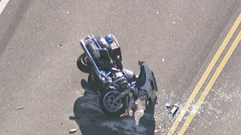 Motorcycle officer taken to hospital after crash in Belmont