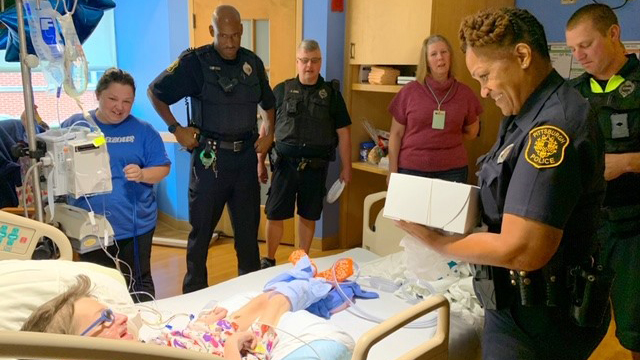 Officers visit with little boy at Children's Hospital who loves police
